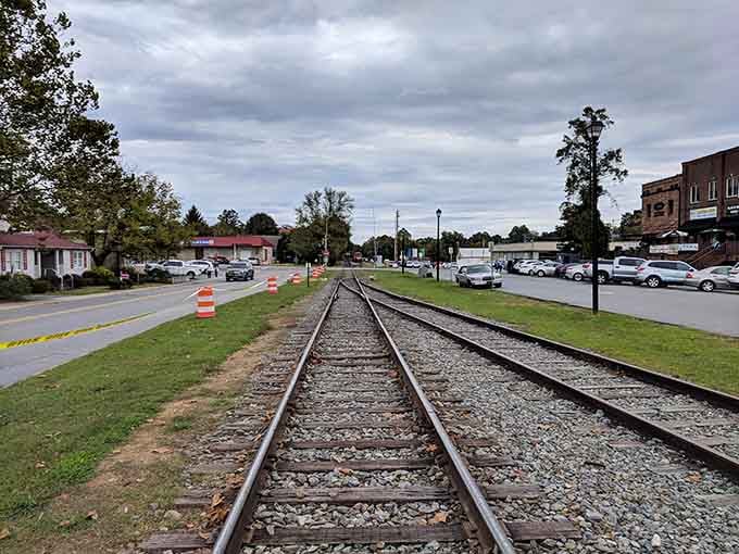 Railroad tracks cutting through town center tell stories of commerce and connection from a bygone era of steam and steel.