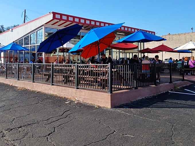 Bright blue and red umbrellas packed with happy diners on a sunny afternoon, this patio is pure Richmond joy.