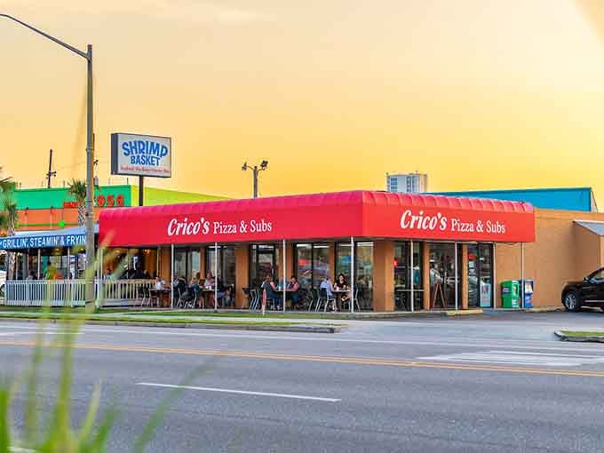 Golden Gulf Coast sunset, happy diners on the patio, and Crico's glowing red sign, this is what a perfect evening looks like.