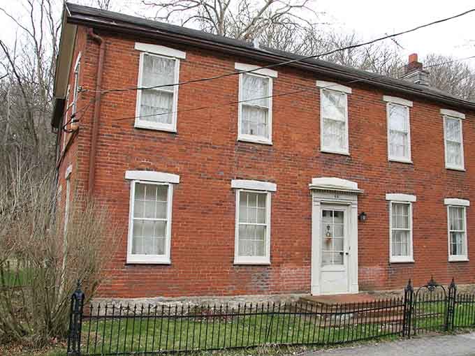 This sturdy red brick Federal-style home in Elsah carries the quiet dignity of a building that has absolutely earned its wrinkles.
