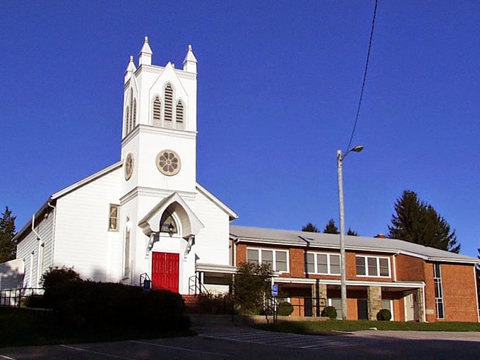 White church steeple reaches toward brilliant blue sky in this picture-perfect Fork neighborhood scene.