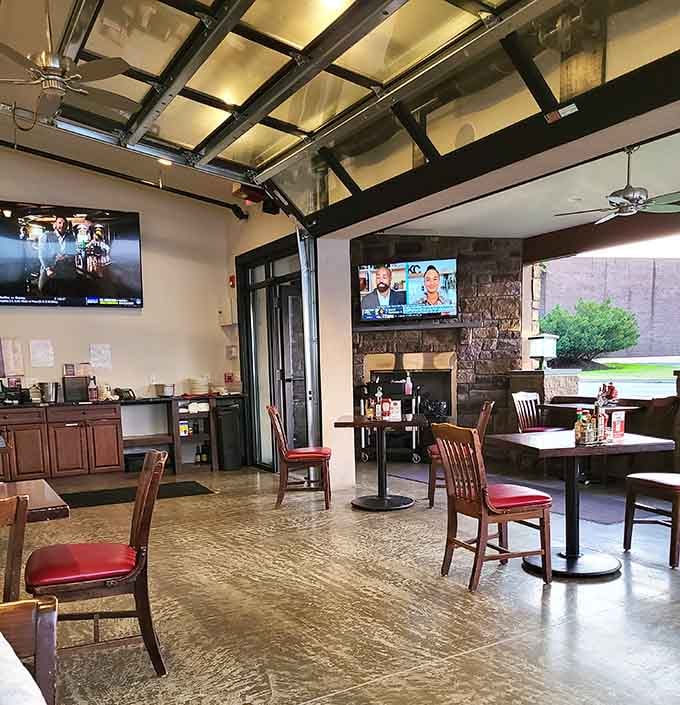 Garage doors rolled up, a stone fireplace glowing, TVs humming — Franklin's tavern area is the definition of relaxed and ready.