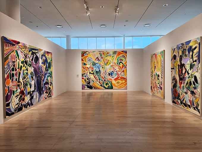 Bold, floor-to-ceiling canvases fill the gallery with color so alive it practically hums right off the walls.