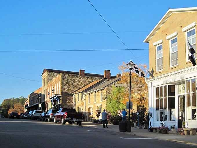 Golden afternoon light washes over Mineral Point's stone buildings, making this Wisconsin street feel like a painting you can actually walk into.