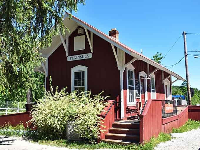 This cherry-red Peninsula depot sits beneath weeping willows like a storybook illustration that somehow became real life.