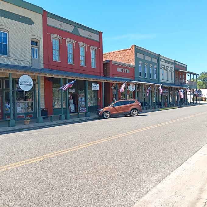 Colorful storefronts and a row of flags make this Georgia block feel like America's most patriotic postcard.