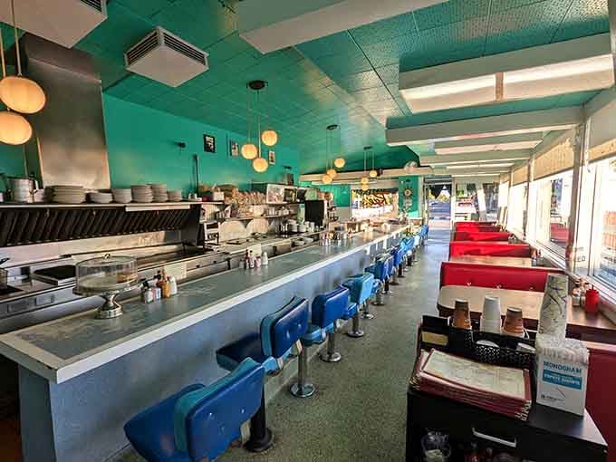 Blue counter stools, red vinyl booths, and a wide-open kitchen &mdash; Rae's interior is a masterclass in honest, no-nonsense diner design.