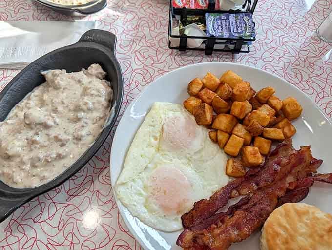 Eggs, bacon, crispy home fries, a biscuit, and sausage gravy. Morning never looked this unapologetically good.