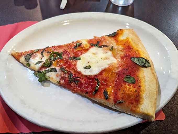 Fresh mozzarella, bright basil, golden crust. This Margherita slice is proof that beautiful things come in simple packages.