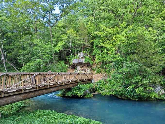 That wooden footbridge over crystal-clear water is the kind of crossing that makes you slow your pace.