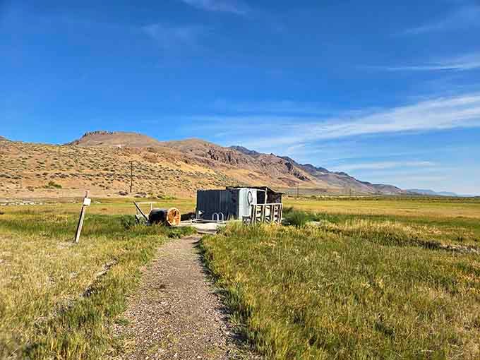 A gravel path, a rustic bathhouse, and a mountain backdrop that makes every step feel like walking into a painting.