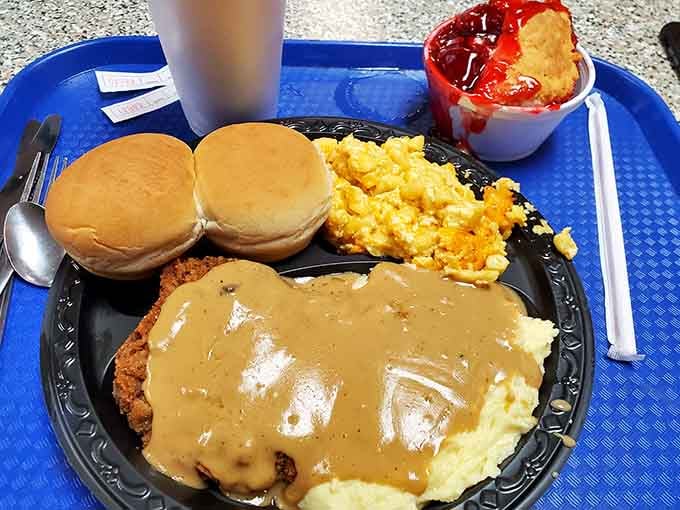 Country fried steak buried under gravy, with biscuits standing by &mdash; comfort food reporting for serious duty.