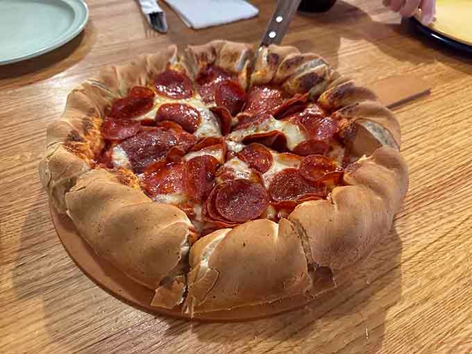 Classic pepperoni, golden crust, and that signature rolled edge just waiting for its honey moment. Pure mountain comfort.