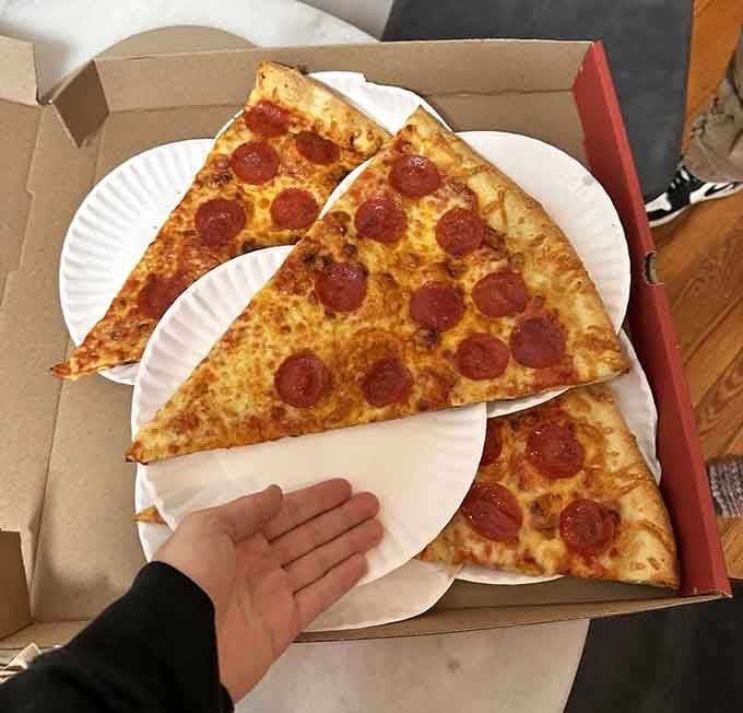 Three slices of pepperoni perfection that could feed a small village or one very determined person.