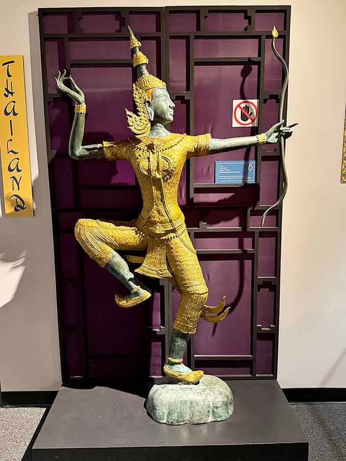 This gilded Thai archer frozen mid-stride carries centuries of Southeast Asian artistry in every intricate detail.