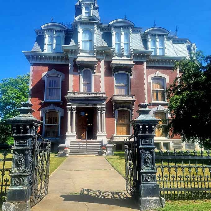 The Phelps Mansion Museum stands like a Victorian dream, iron gates and all, daring you to ring the bell.