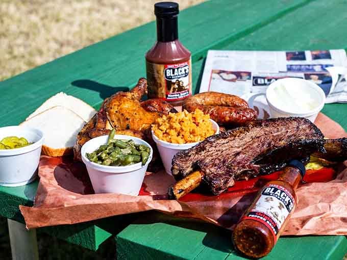 Ribs, sausage, chicken, and sides all on one tray. This is what a good day looks like, full stop.