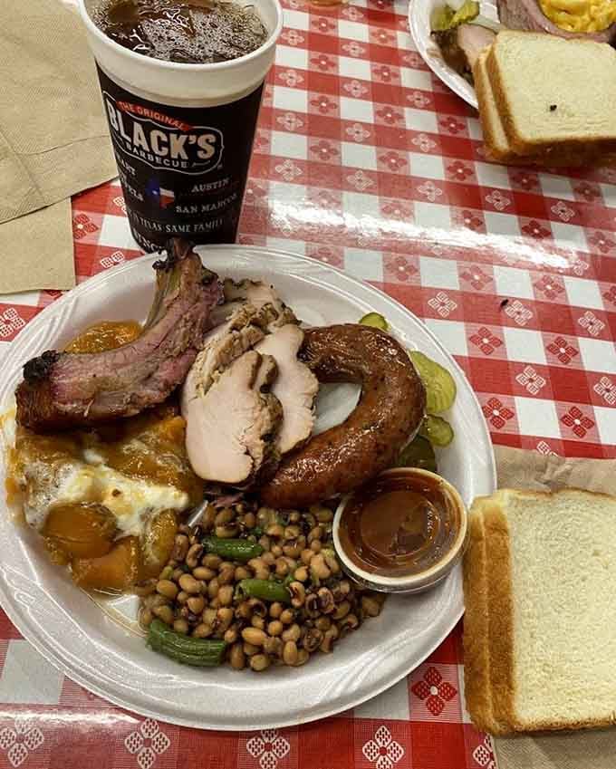 Ribs, turkey, sausage, and sides all sharing one plate, this is what a barbecue greatest hits album looks like.