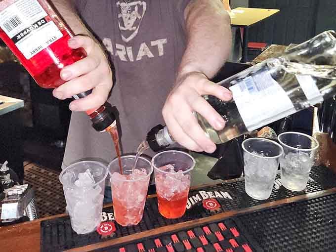 Behind the bar, skilled hands pour colorful concoctions that might just steady your nerves for what's ahead.