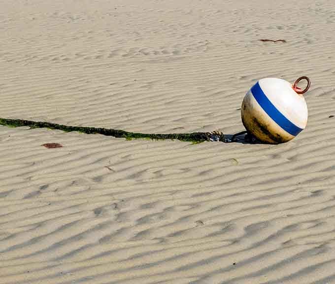 Even a stranded buoy looks poetic out here, sitting quietly on the rippled Brewster Tidal Flats sand.
