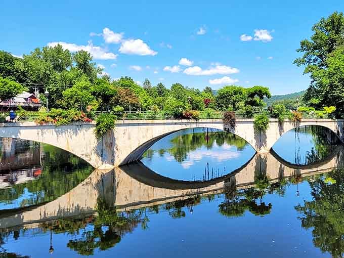 Lush garden beds stretching the full length of the bridge, with green hills framing everything perfectly.