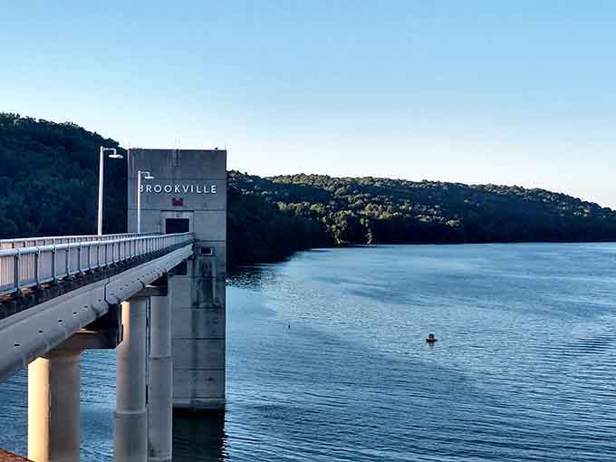 The dam stands guard over thousands of acres of water, silently inviting fishermen and daydreamers to test their luck.