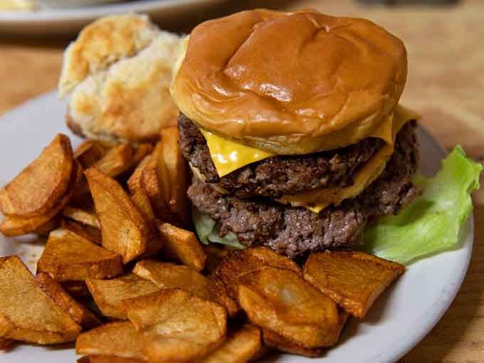 Two patties, melted cheese, and a golden bun surrounded by thick-cut fried potatoes &mdash; this burger means serious business.