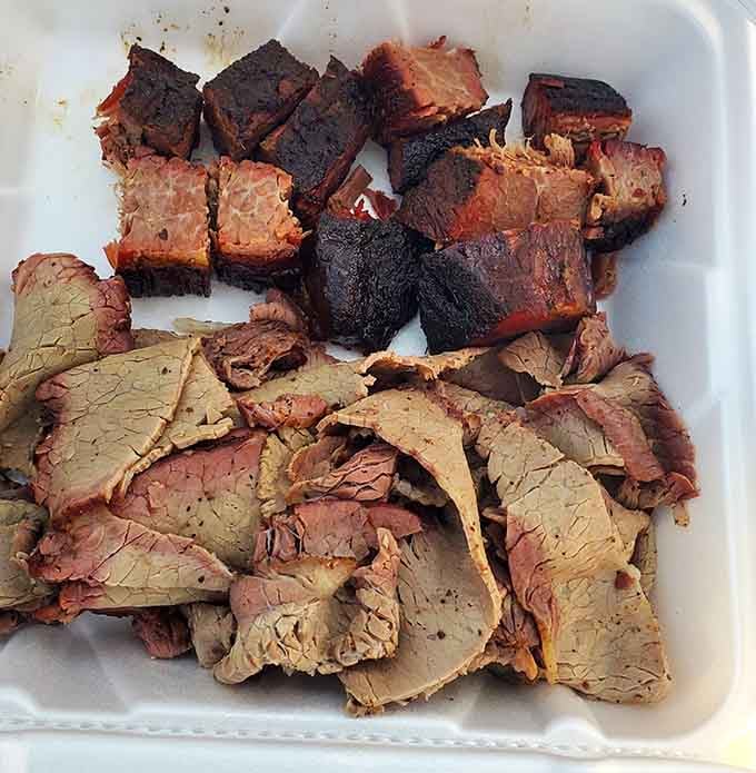 Caramelized burnt ends up top, tender sliced brisket below, this tray is what patience and a good smoker produce together.