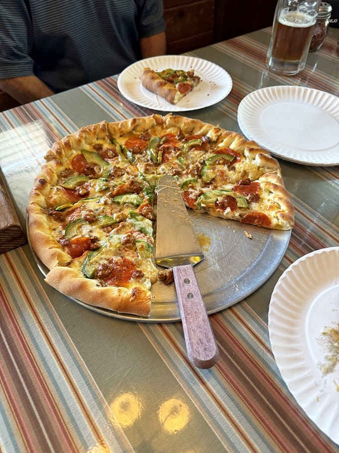 Pepperoni, sausage, bell peppers, and zucchini piled high. This pizza means serious, delicious business.