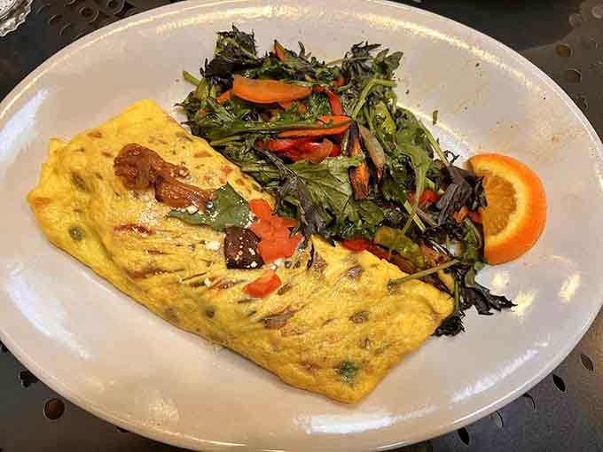 A perfectly folded omelet with sautéed greens proves breakfast doesn't have to choose between healthy and delicious.