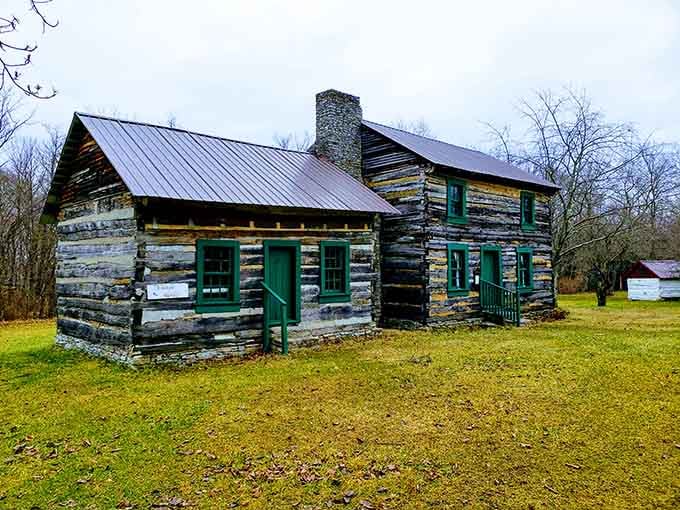 A genuine 19th-century log cabin standing quietly in the woods, reminding you that history has good bones.