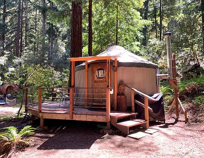 A yurt, a deck, and towering redwoods walk into a campground. The punchline is that you get to sleep there.