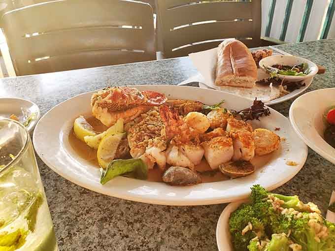 Scallops, shrimp, and lobster tail sharing one plate. Someone in that kitchen really understands happiness.