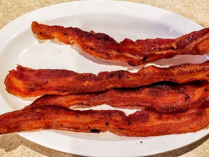 Perfectly crispy bacon strips with those caramelized edges prove that some things never go out of style, thank goodness.