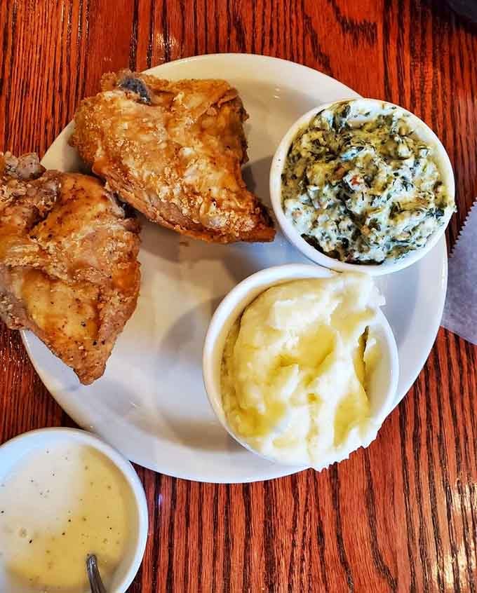 Golden, crackling fried chicken beside creamed spinach and mashed potatoes. Sunday dinner just showed up on a Tuesday.