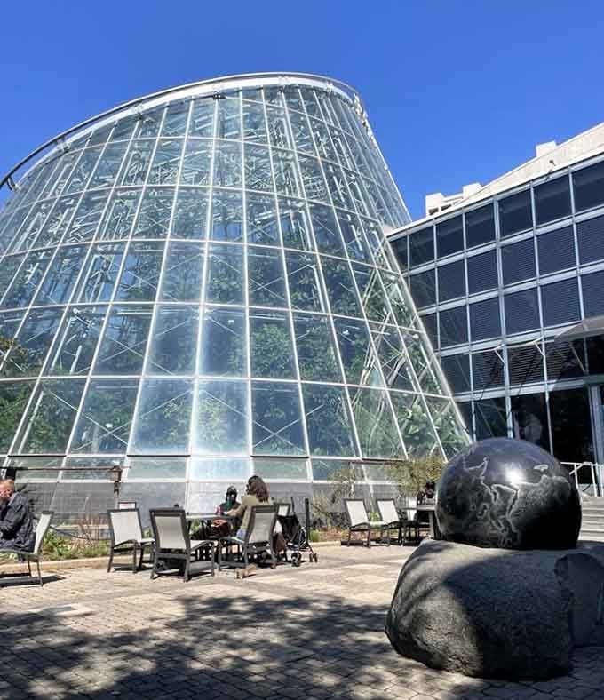 That gleaming conservatory isn't a spaceship, though stepping inside will transport you to another world entirely, humidity and all.