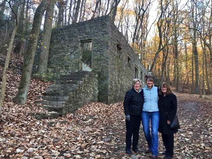 Three visitors, one incredible backdrop. The Colonial Springs ruins make everyone look like an explorer.