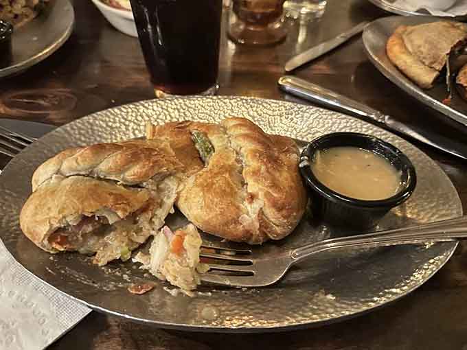 Golden pastry perfection with a side of rich gravy, this is what handheld comfort looks like in its finest form.