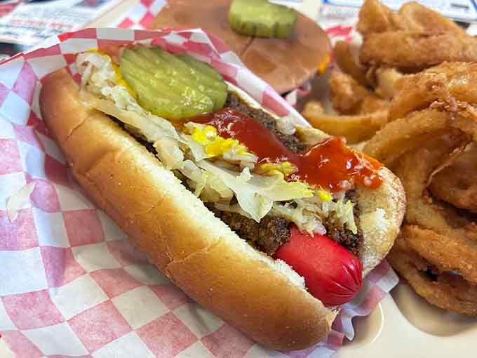 Homemade chili, sauerkraut, mustard, ketchup, and pickles. This hot dog didn't come to play around.
