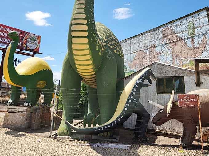 Up close with the crew, where a massive brontosaurus towers over its smaller prehistoric pals.