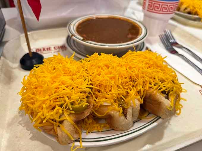 Behold the cheese coney in all its glory—a hot dog buried under chili and cheddar like treasure beneath golden waves.