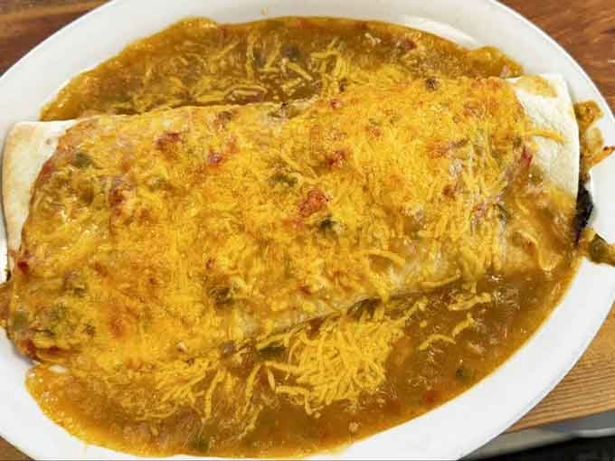 That burrito isn't just smothered in green chili and melted cheese. It's a full life decision.