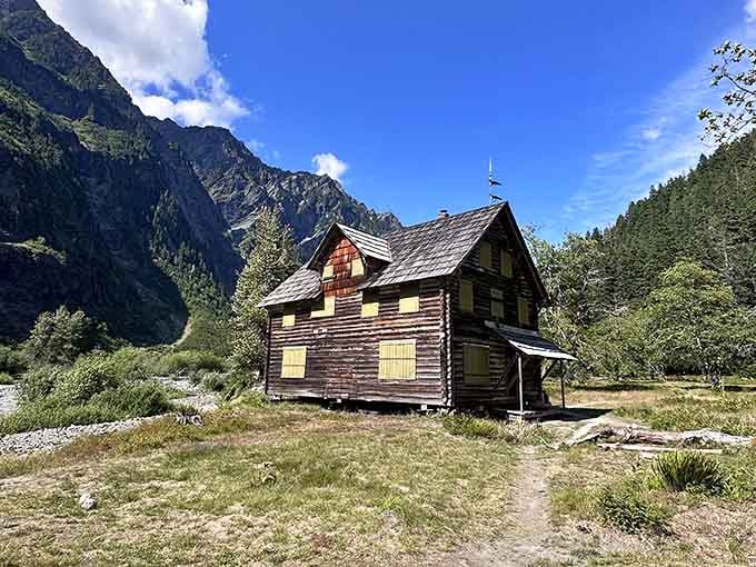 The Enchanted Valley Chalet sits there like a postcard that somehow became three-dimensional and real.