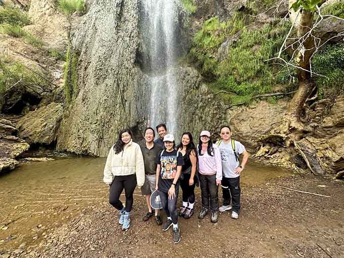 Nothing says "we earned this" quite like a group photo with a roaring waterfall as your backdrop.