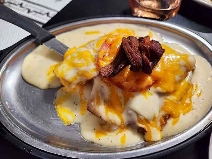 The Hot Brown arrives like a warm hug from Kentucky itself, draped in homemade cheese gravy and crowned with crispy bacon.