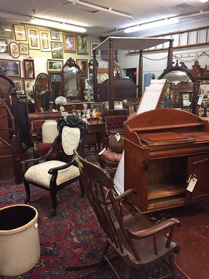 A four-poster bed, carved mirrors, and wingback chairs, this booth is basically a Victorian parlor that got very ambitious.