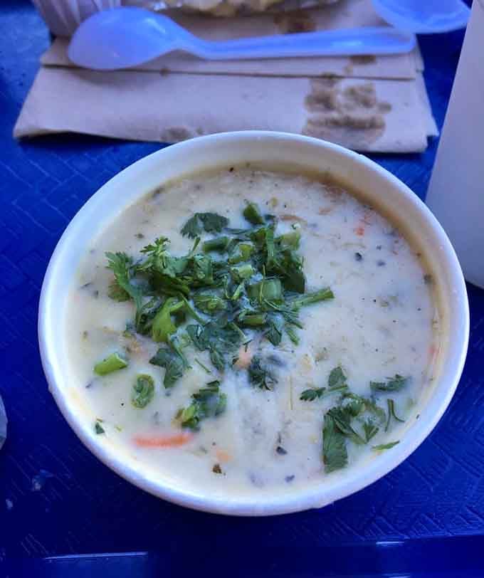 Charlie's Famous Clam Chowder arrives creamy, thick, and topped with fresh cilantro. This bowl means serious business.