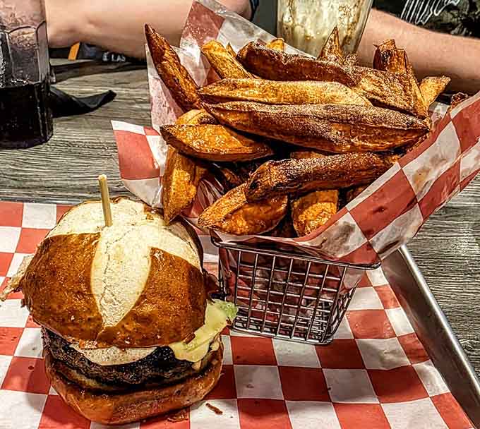 Golden sweet potato fries piled high next to a juicy burger is the kind of combo that makes Tuesday feel like a celebration.