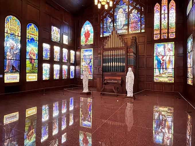 A vintage pipe organ anchors one corner, surrounded by windows so vivid they practically hum with color.