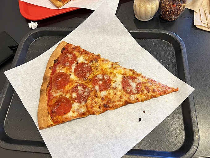 One pepperoni slice so gloriously oversized it makes every other pizza you've eaten feel like it was holding back.
